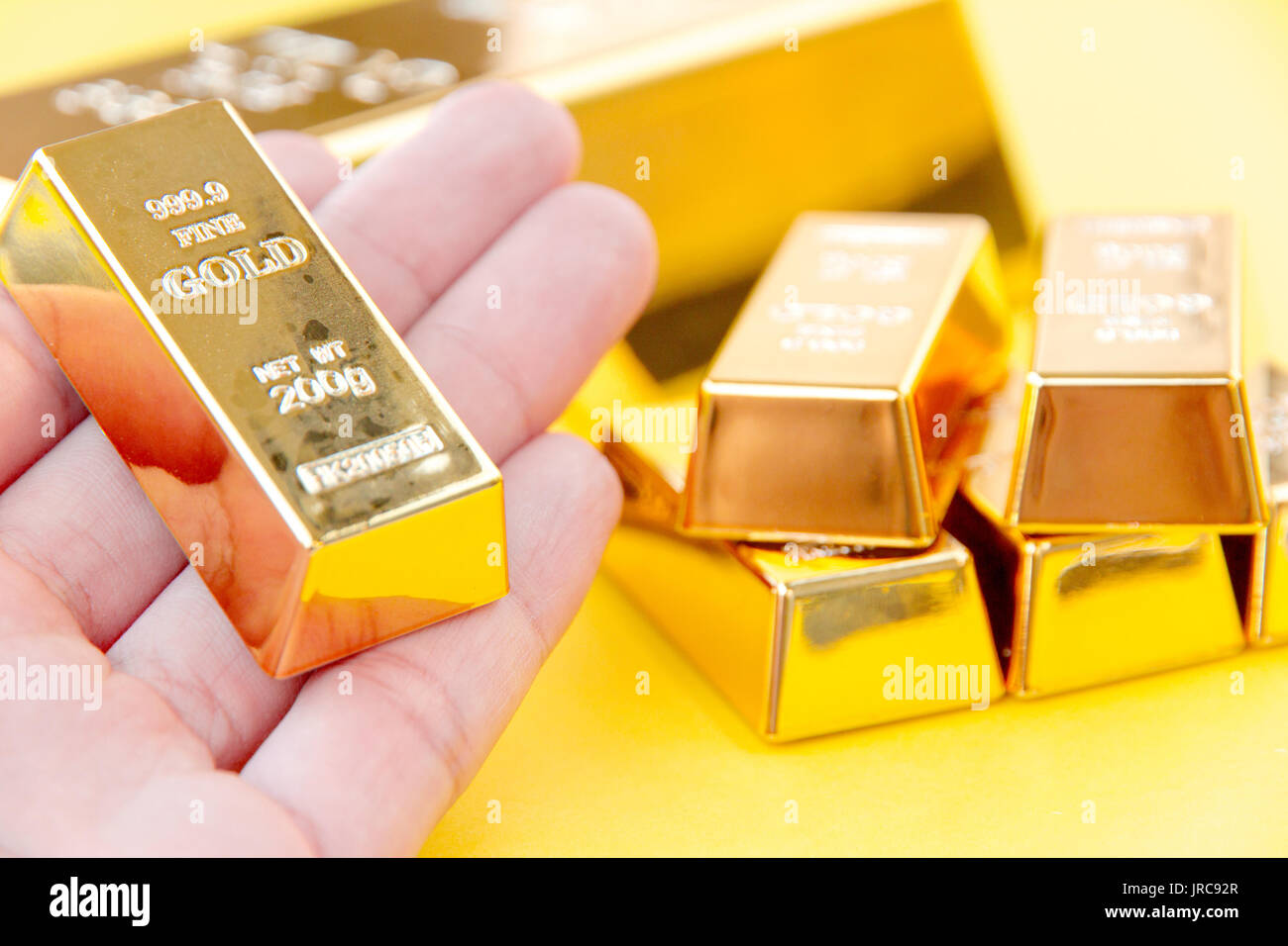 Hand hold gold bars Stock Photo - Alamy