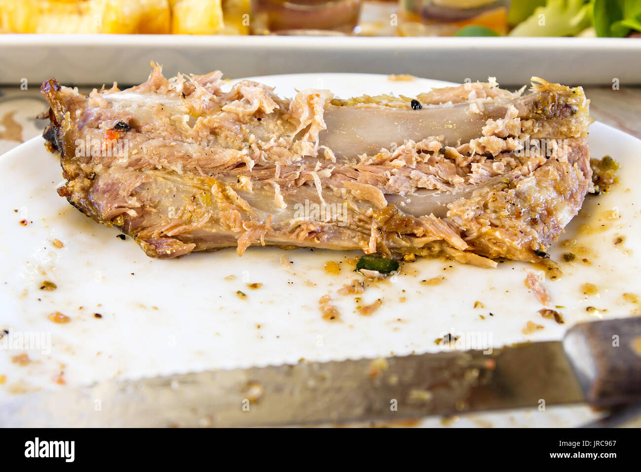 Dirty and empty steak dish with rib bone Stock Photo - Alamy