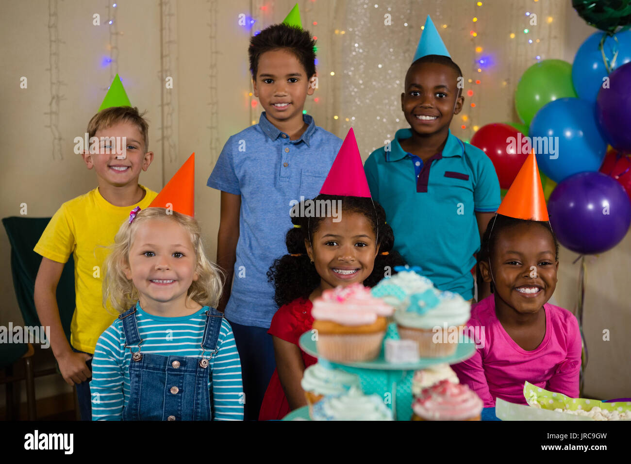 Smiling sitting bonding childhood celebration party hat hi-res stock ...
