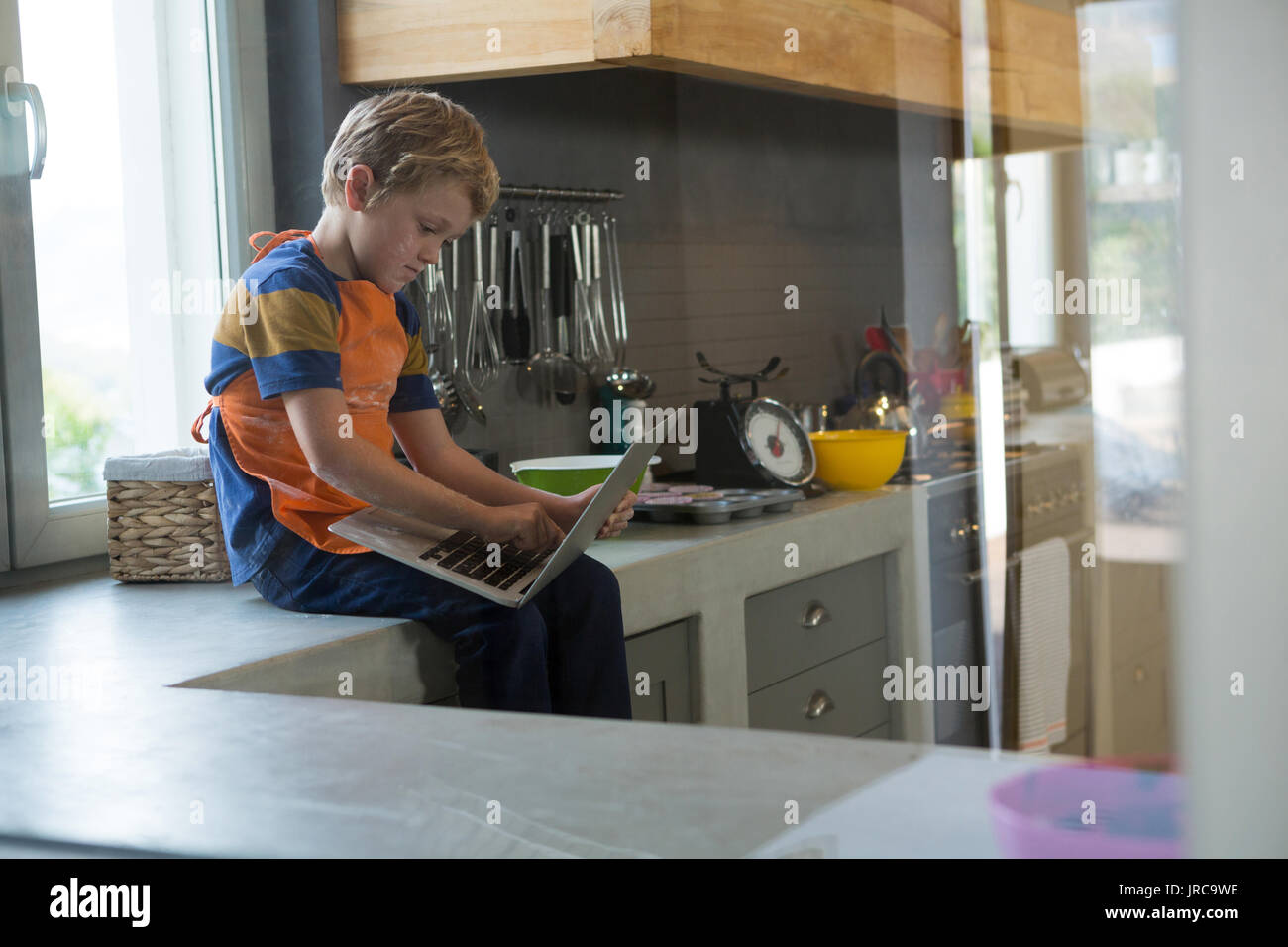 Boy sitting on counter hi-res stock photography and images - Alamy