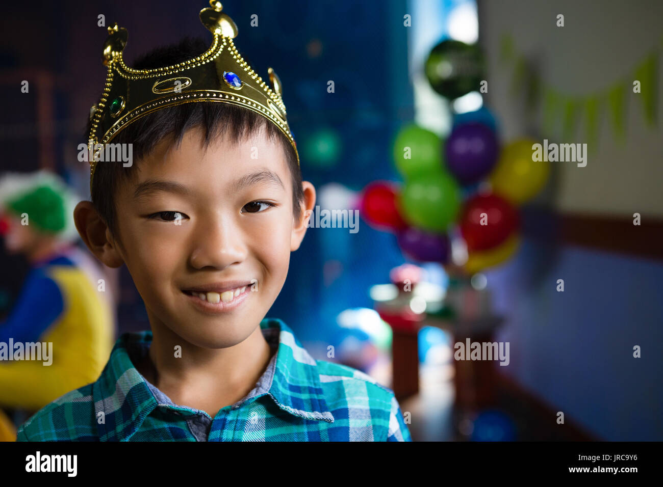 Portrait of boy wearing crown during party Stock Photo - Alamy