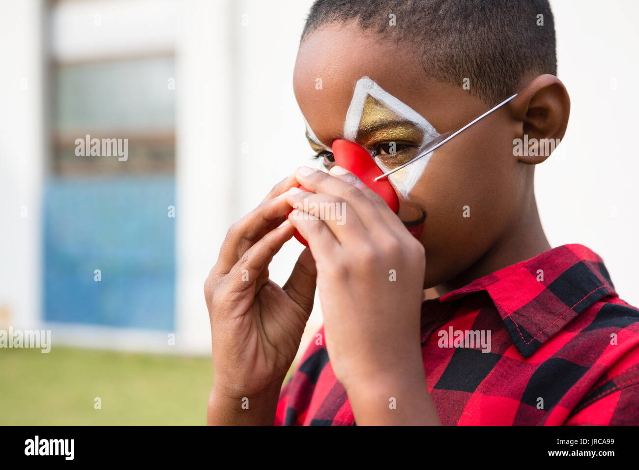 Close up of boy wearing clown nose during birthday party in yard Stock ...
