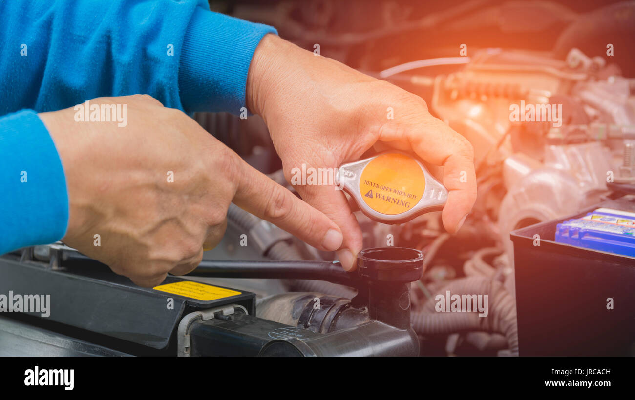 Hand of technician checking engine of car. Auto mechanic checking car ...
