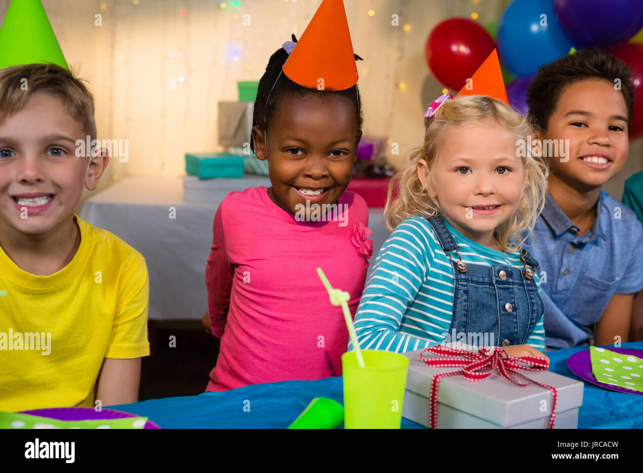 Children sitting around table hi-res stock photography and images - Alamy