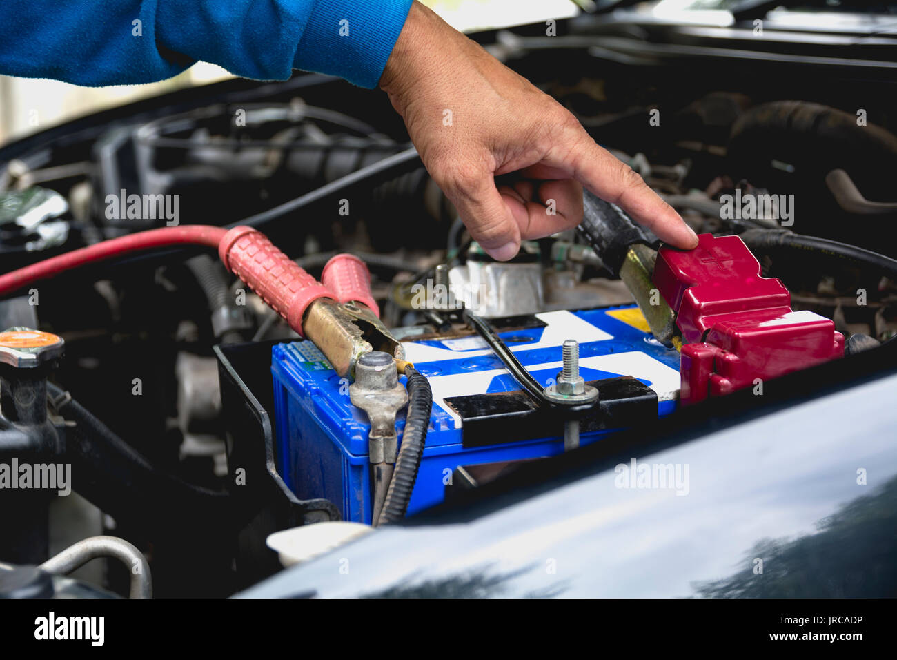 Hand of technician checking engine of car. Auto mechanic checking car ...