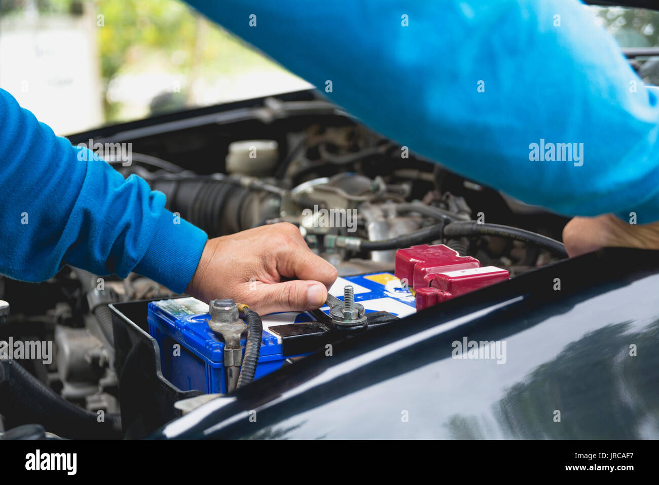 Hand of technician checking engine of car. Auto mechanic checking car ...