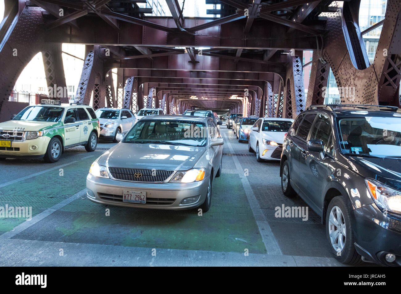 Traffic waiting at the lights on Wells Street Iron Bridge in downtown ...