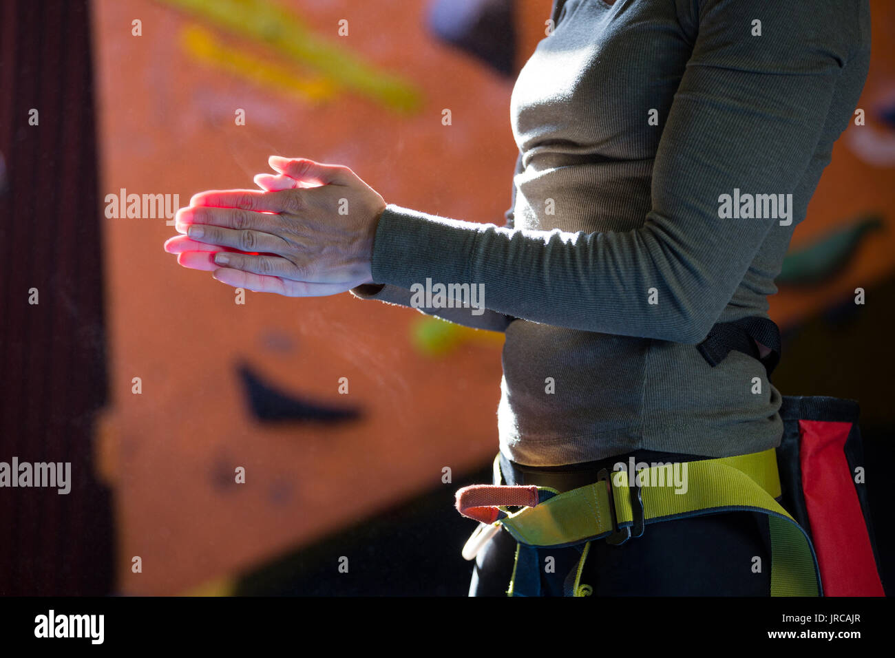 Mid section of woman rubbing powder on hands in fitness studio Stock ...