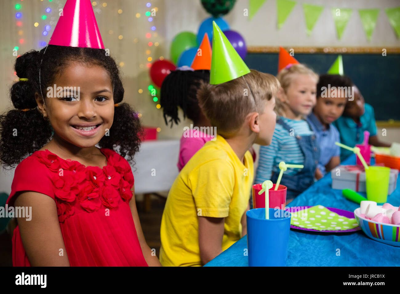 Smiling sitting bonding childhood celebration party hat hi-res stock ...