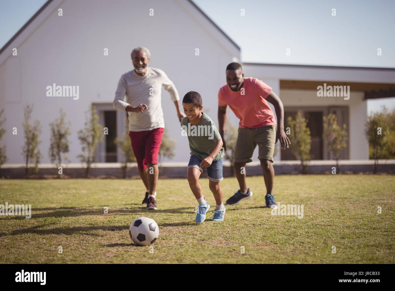 Grandfather grandson playing football hi-res stock photography and ...
