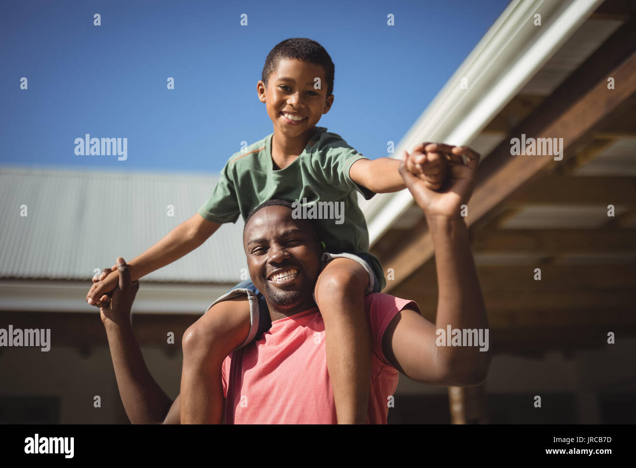 Happy father carrying son on shoulders hi-res stock photography and ...