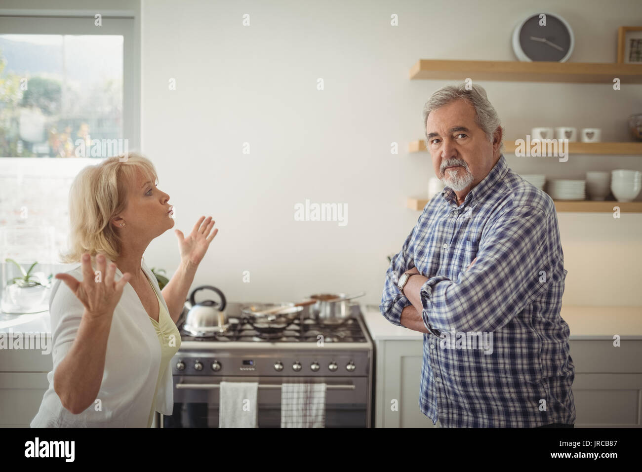 Senior couple arguing in kitchen at home Stock Photo - Alamy