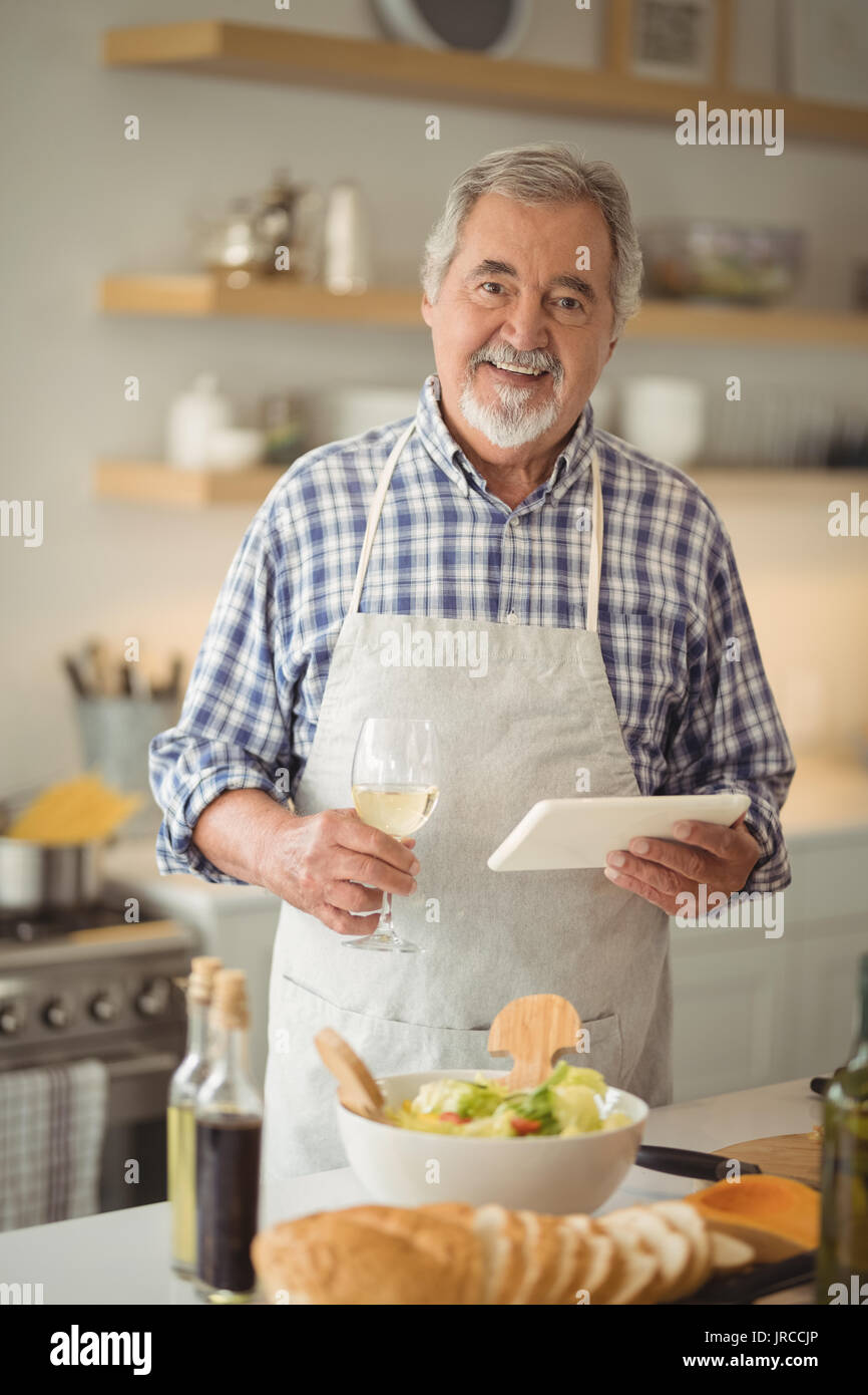 Senior man using digital tablet at home Stock Photo - Alamy