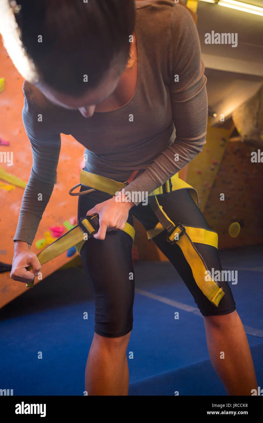 Determined woman wearing safety harness in fitness studio Stock Photo ...