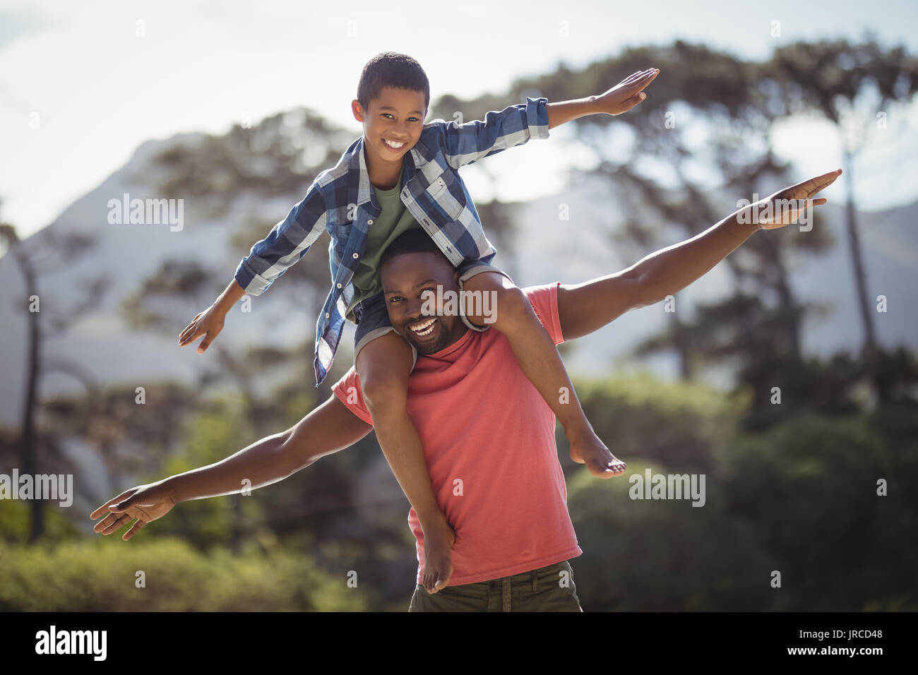 Happy father carrying son on shoulders hi-res stock photography and ...