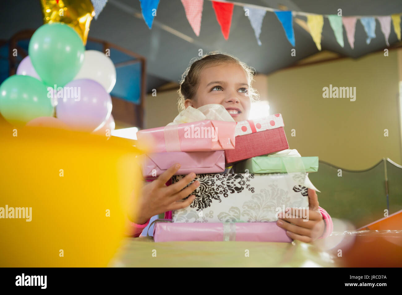 Birthday girl holding various gift boxes at home Stock Photo - Alamy