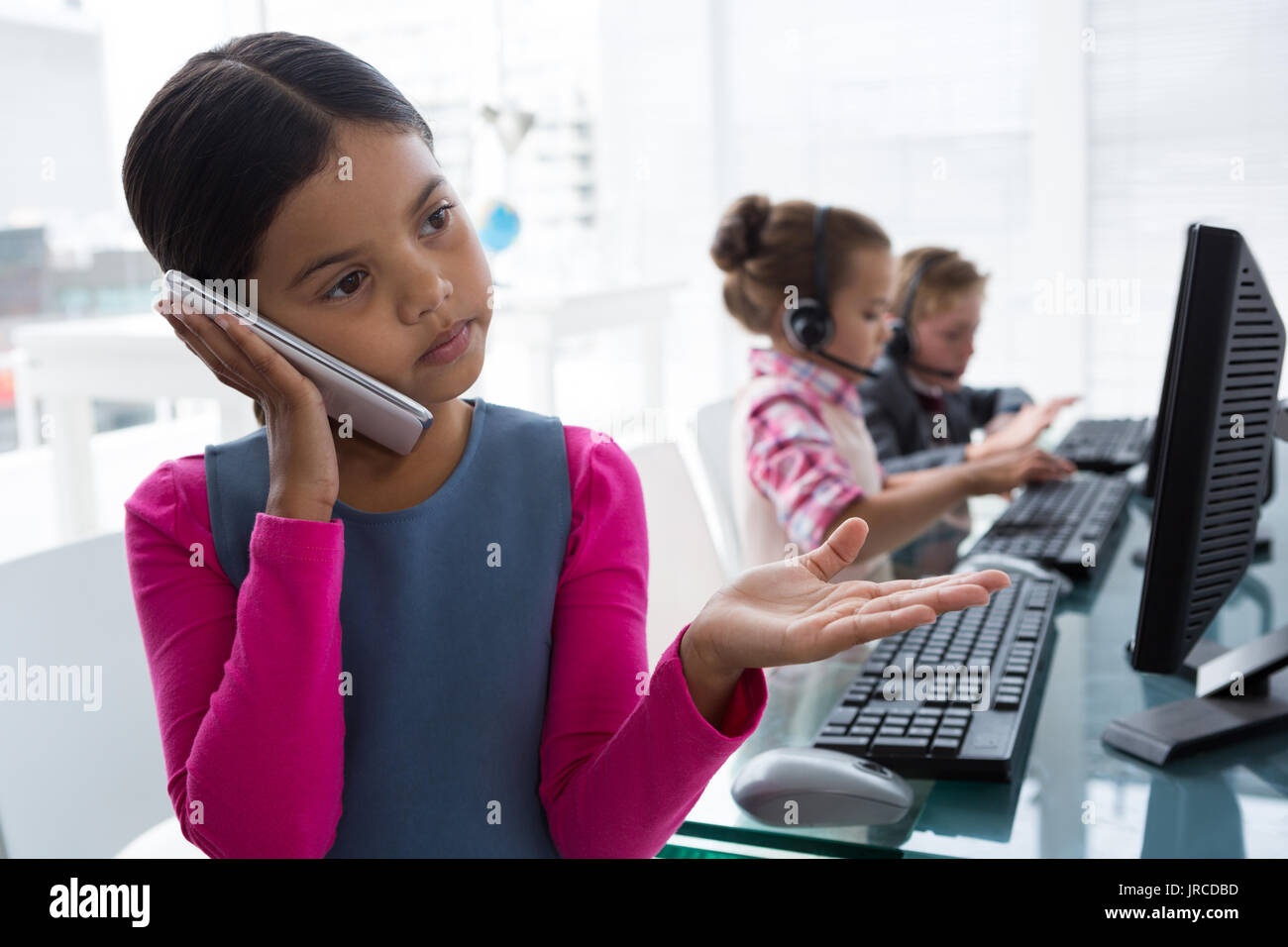Kids using computer in office Stock Photo - Alamy