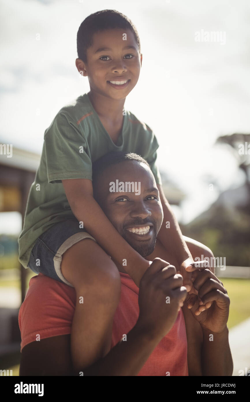 Happy father carrying son on shoulders hi-res stock photography and ...
