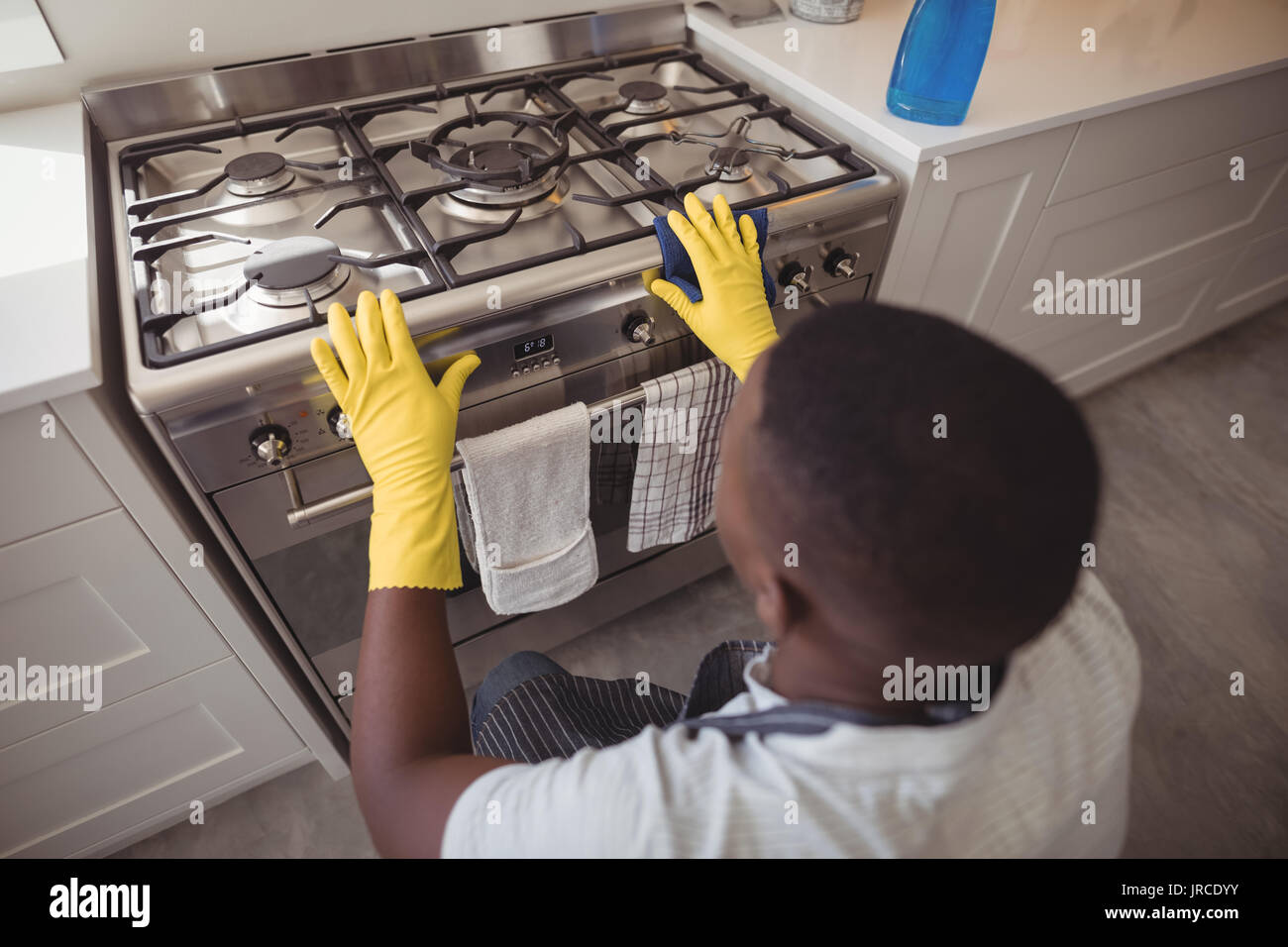 Man checking gas stove in kitchen at home Stock Photo - Alamy