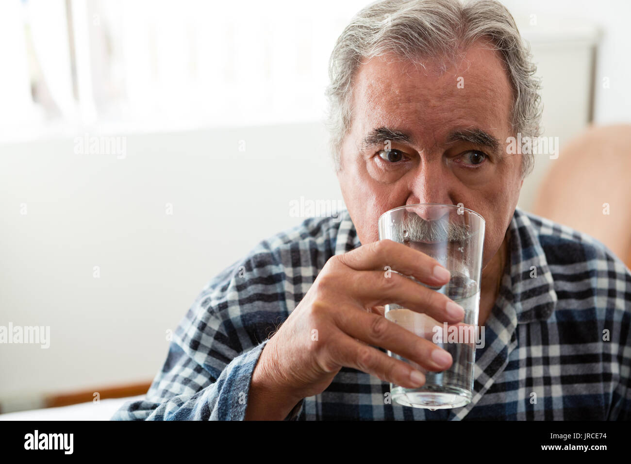 Male patient drinking water hi-res stock photography and images - Alamy