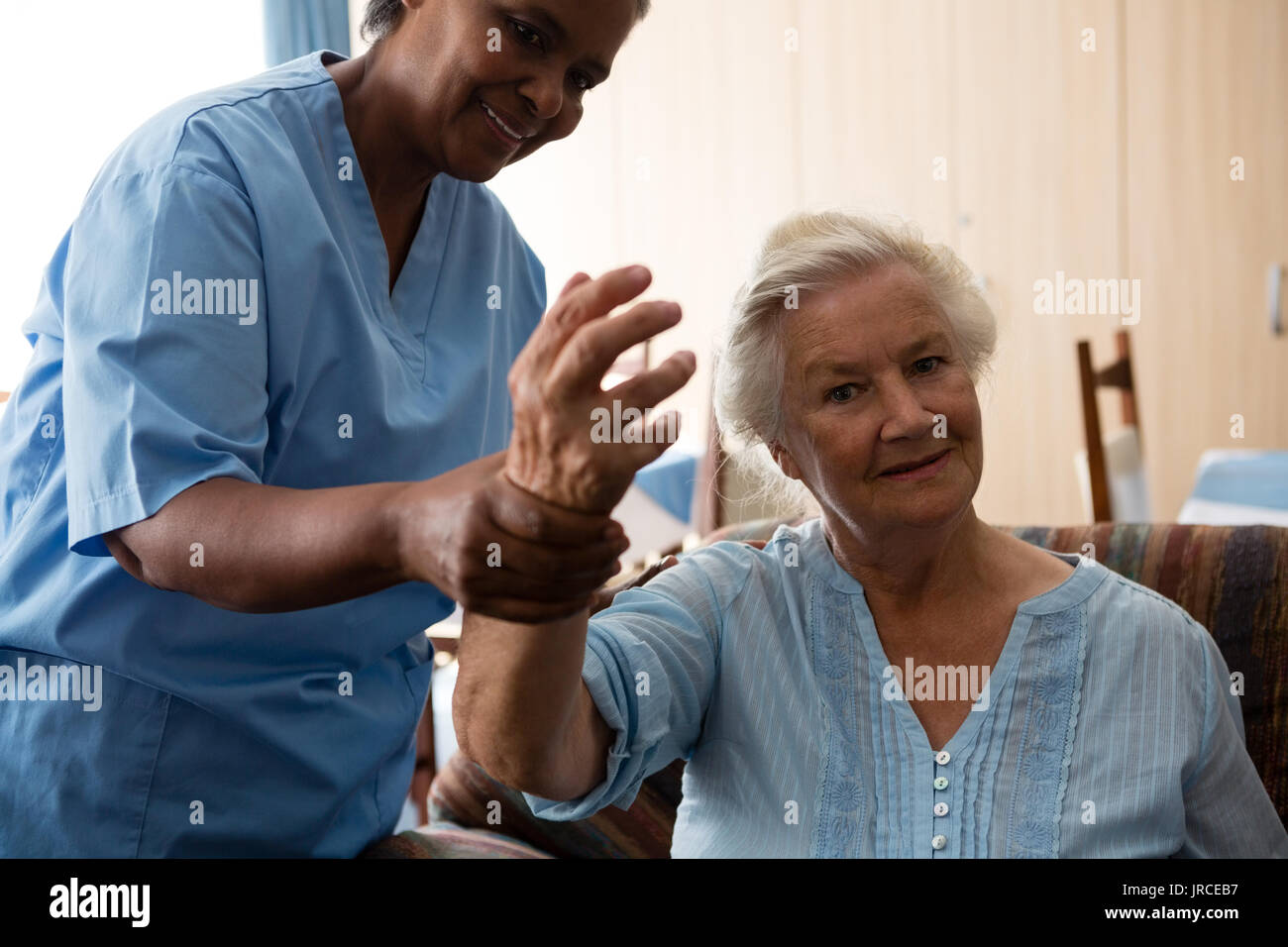 Nurse helping elderly woman Stock Photo - Alamy