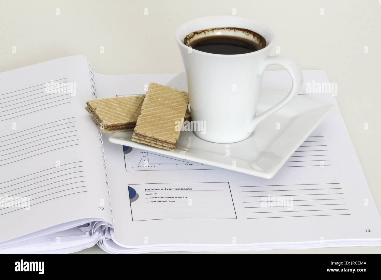 white cup of tea with green notebook and wafers Stock Photo - Alamy