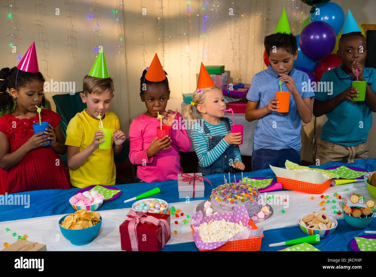 Children having drink during birthday party Stock Photo - Alamy