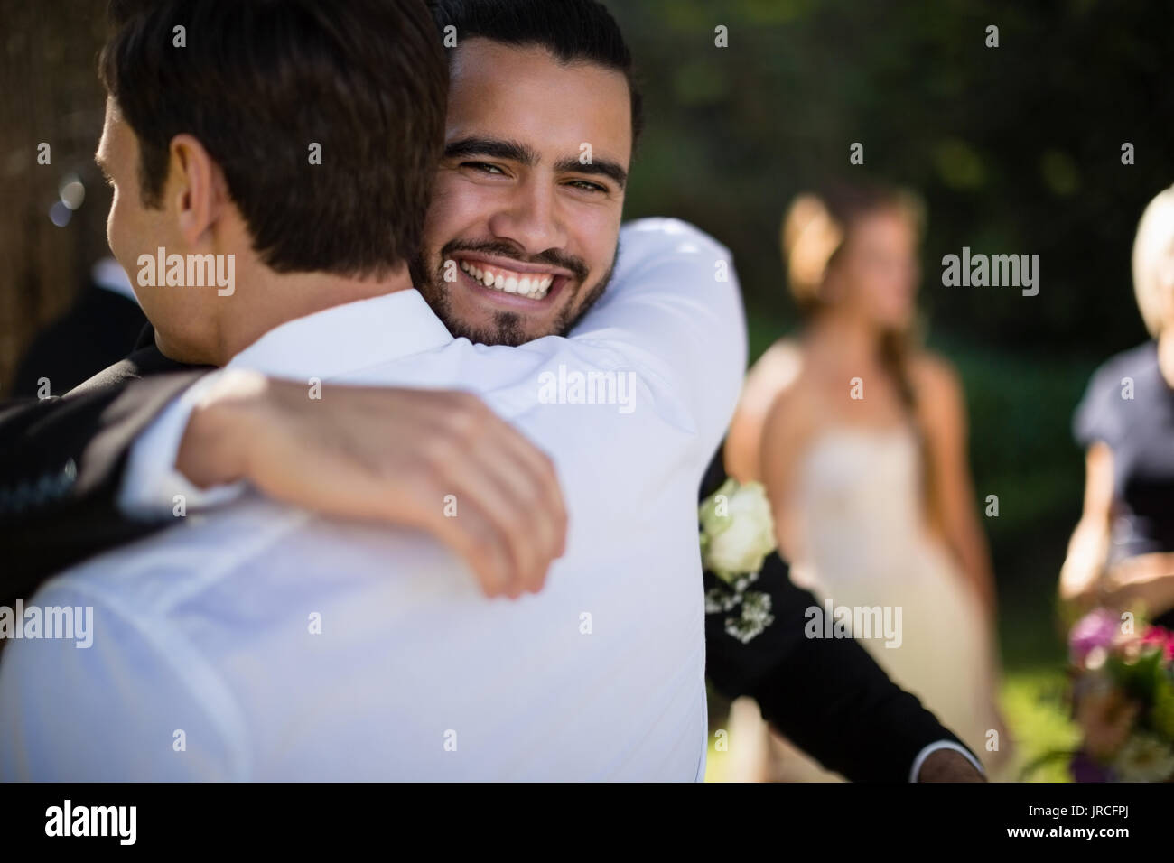 Smart young groom embracing hi-res stock photography and images - Alamy