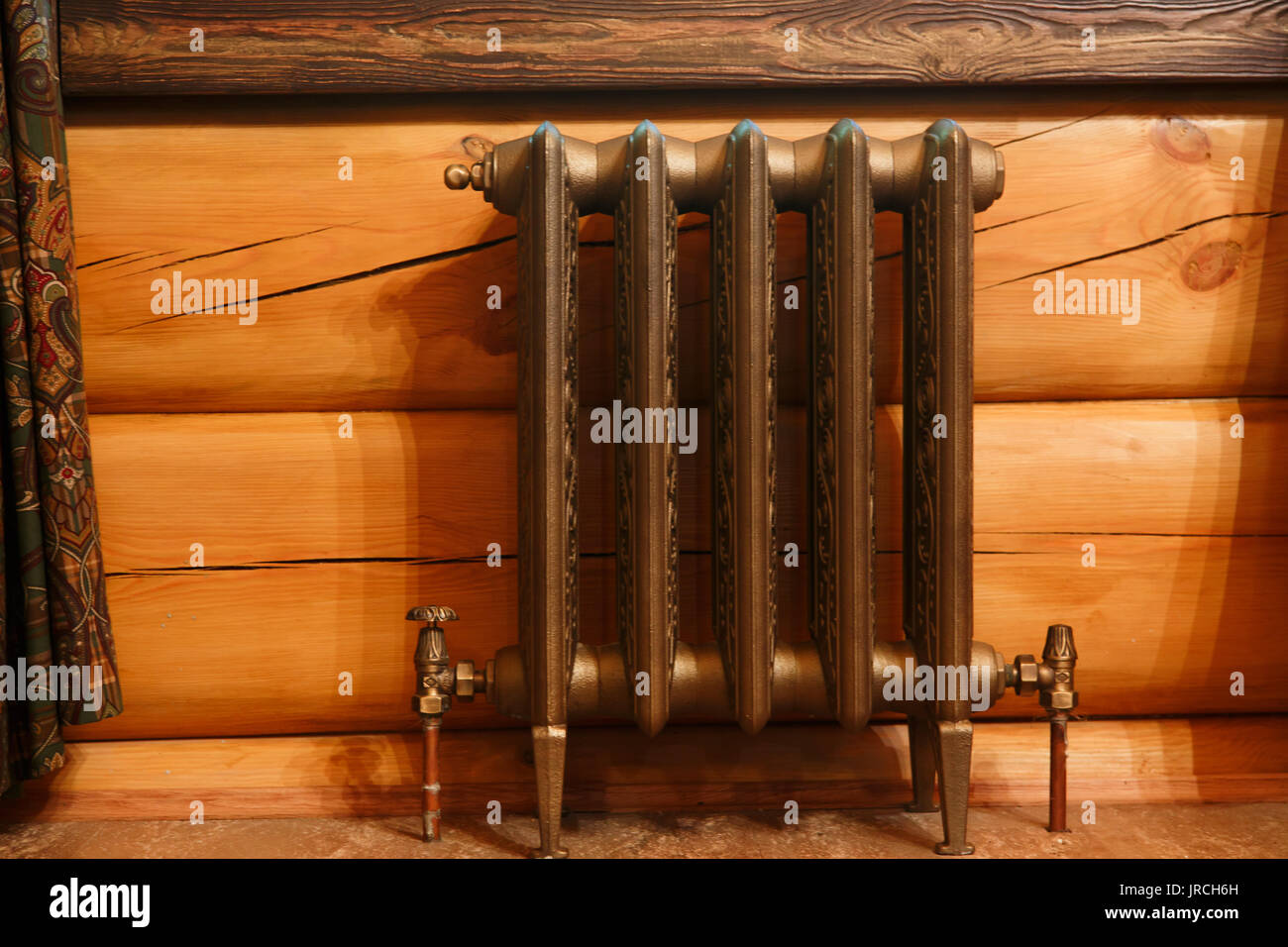 Cast iron retro design radiator in timber house Stock Photo - Alamy