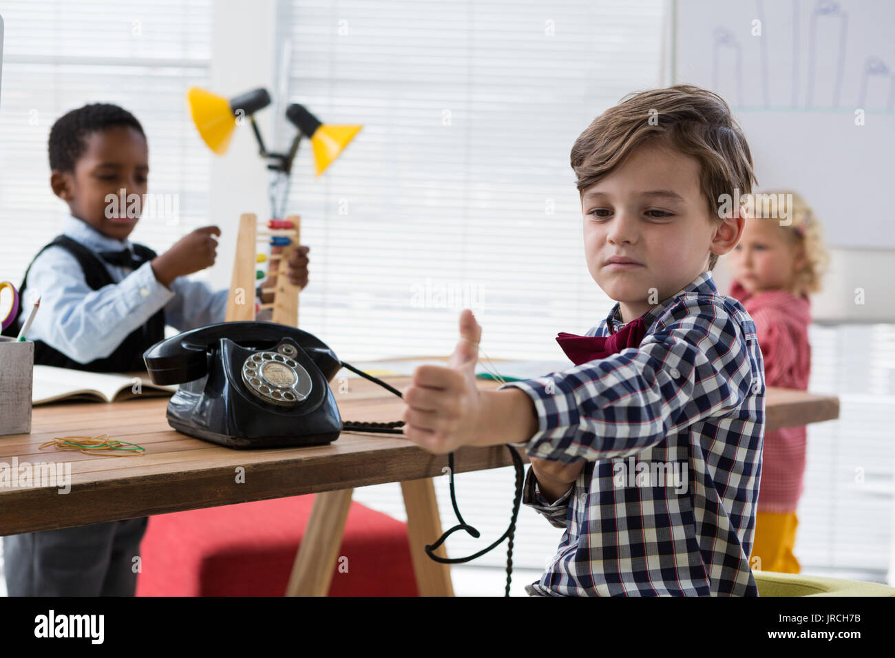 Coworkers working at table in creative office Stock Photo - Alamy