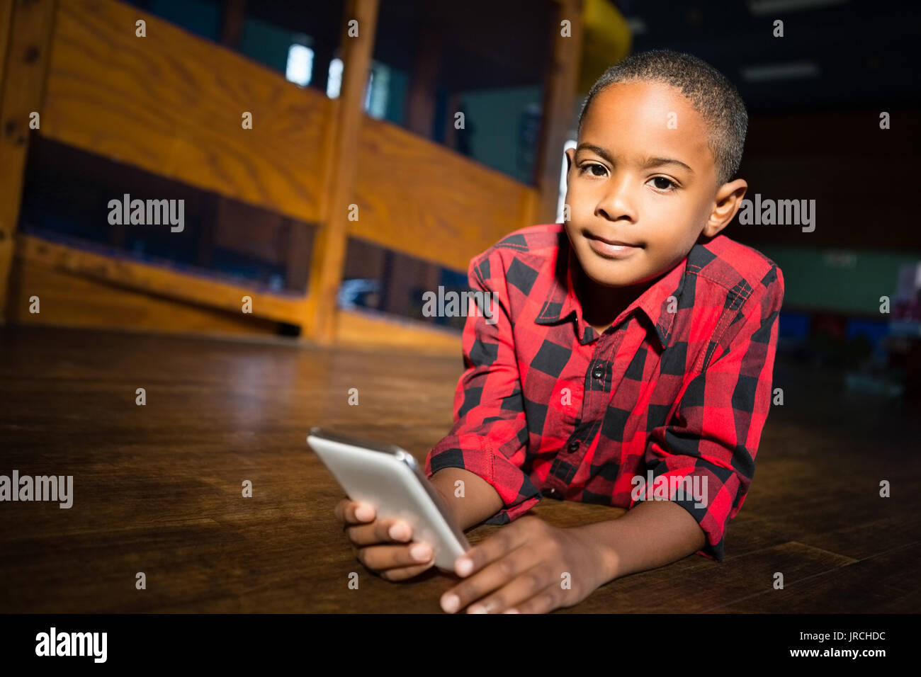 Portrait of cute boy using mobile phone at home Stock Photo - Alamy