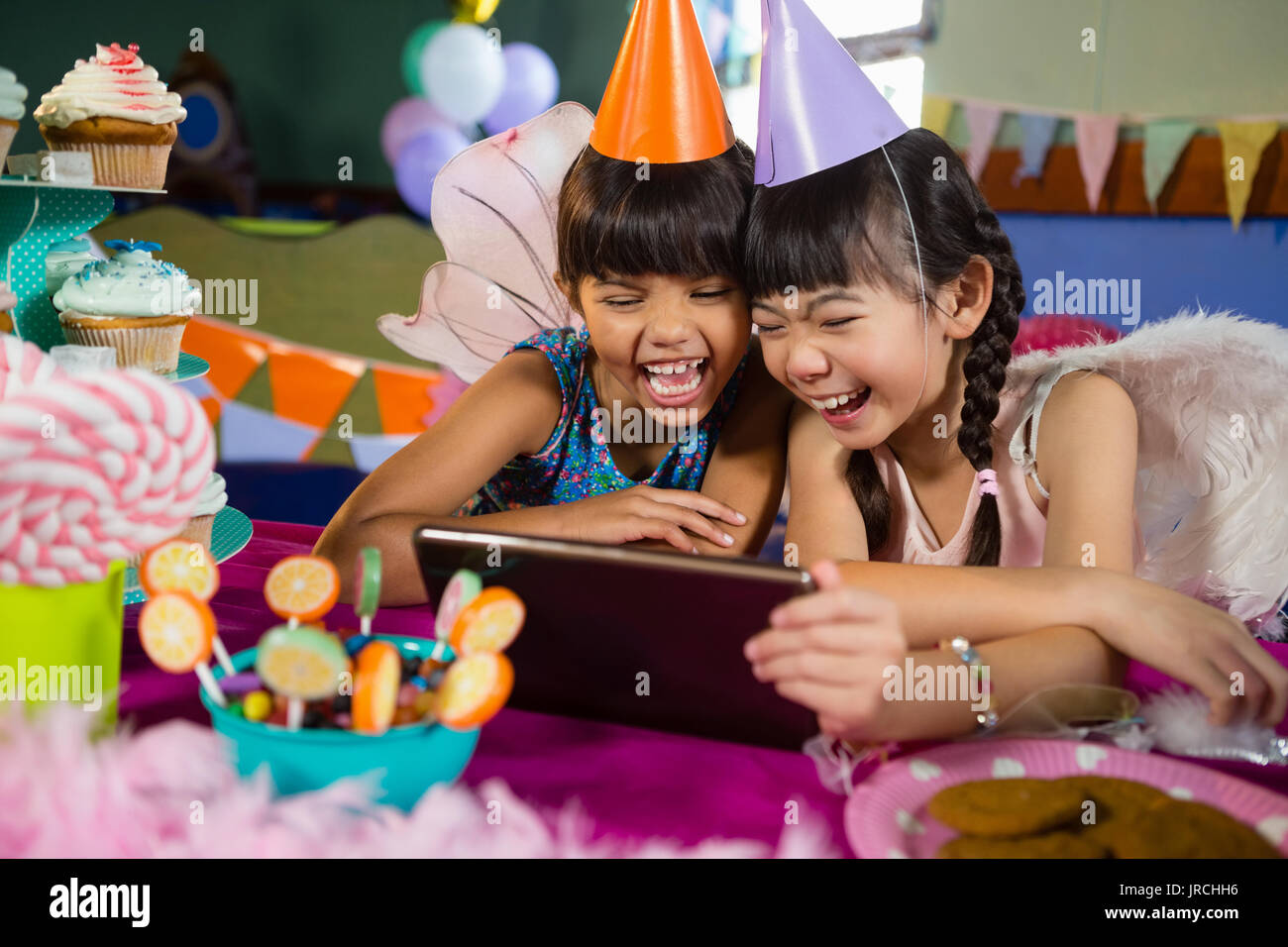 Kids using digital tablet during birthday party at home Stock Photo - Alamy