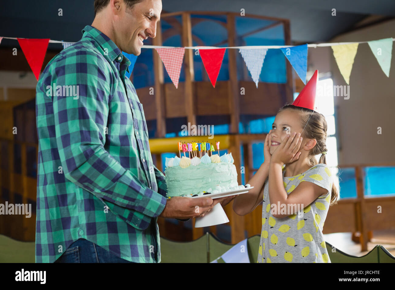 Father giving surprised birthday cake to her daughter at home Stock ...