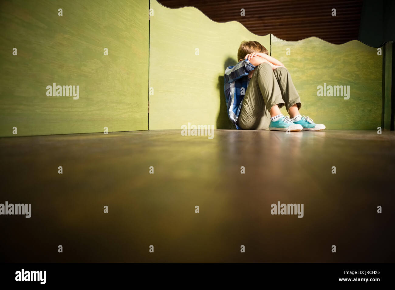 Boy sitting head down sad hi-res stock photography and images - Alamy