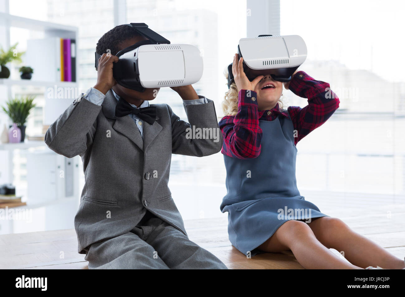 Business people looking through virtual reality simulator while sitting ...