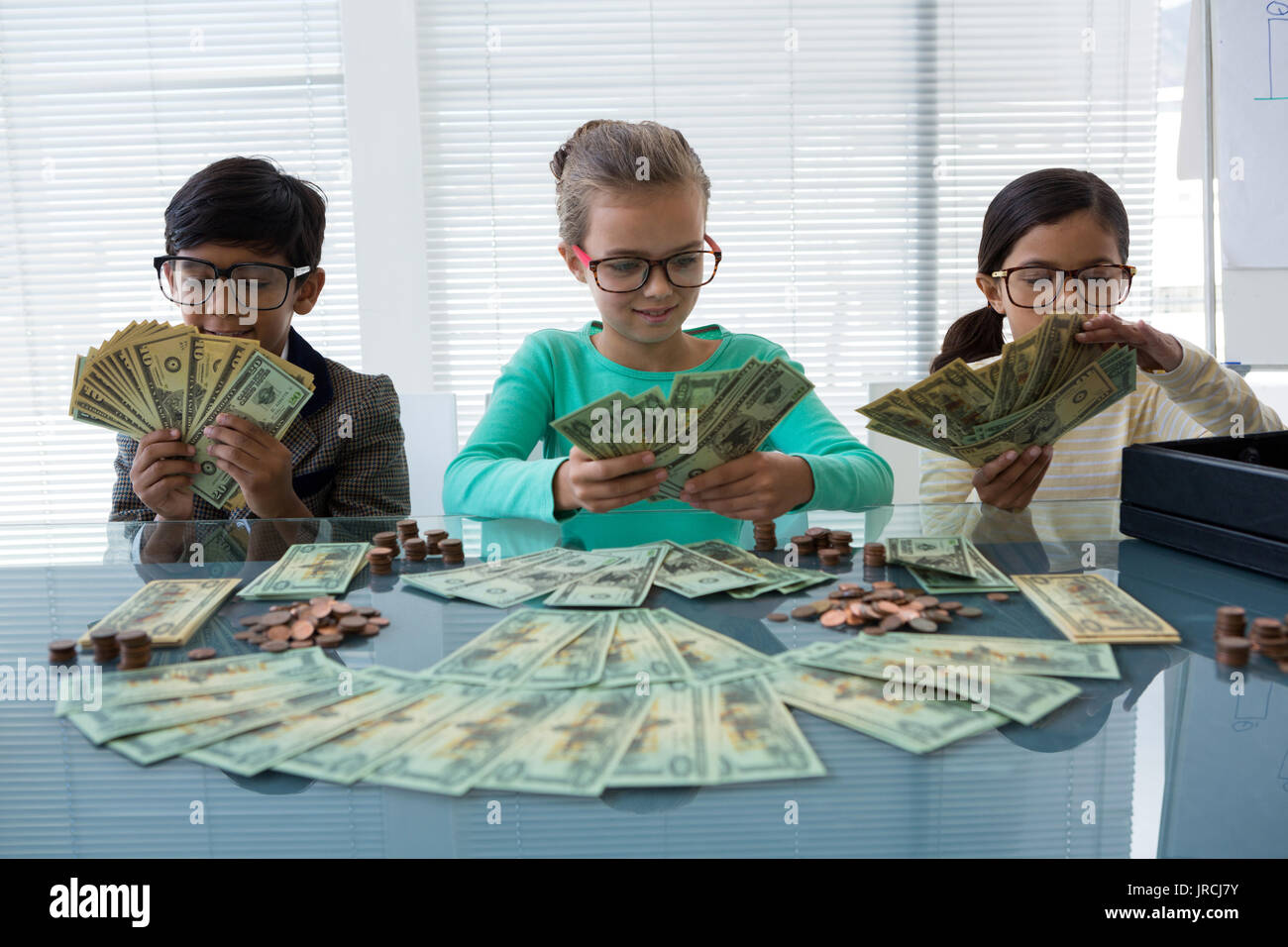 Business people counting money at desk in office Stock Photo - Alamy
