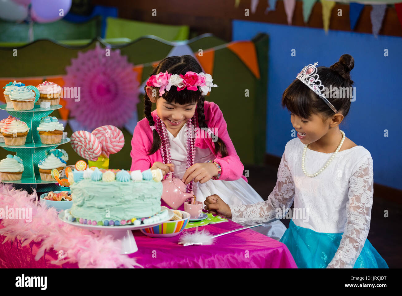 Friends interacting with each other during birthday party at home Stock ...