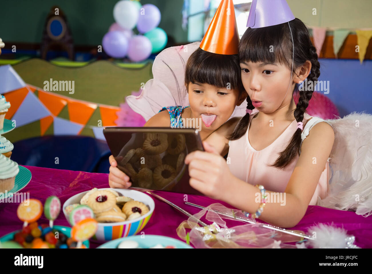 Kids using digital tablet during birthday party at home Stock Photo - Alamy