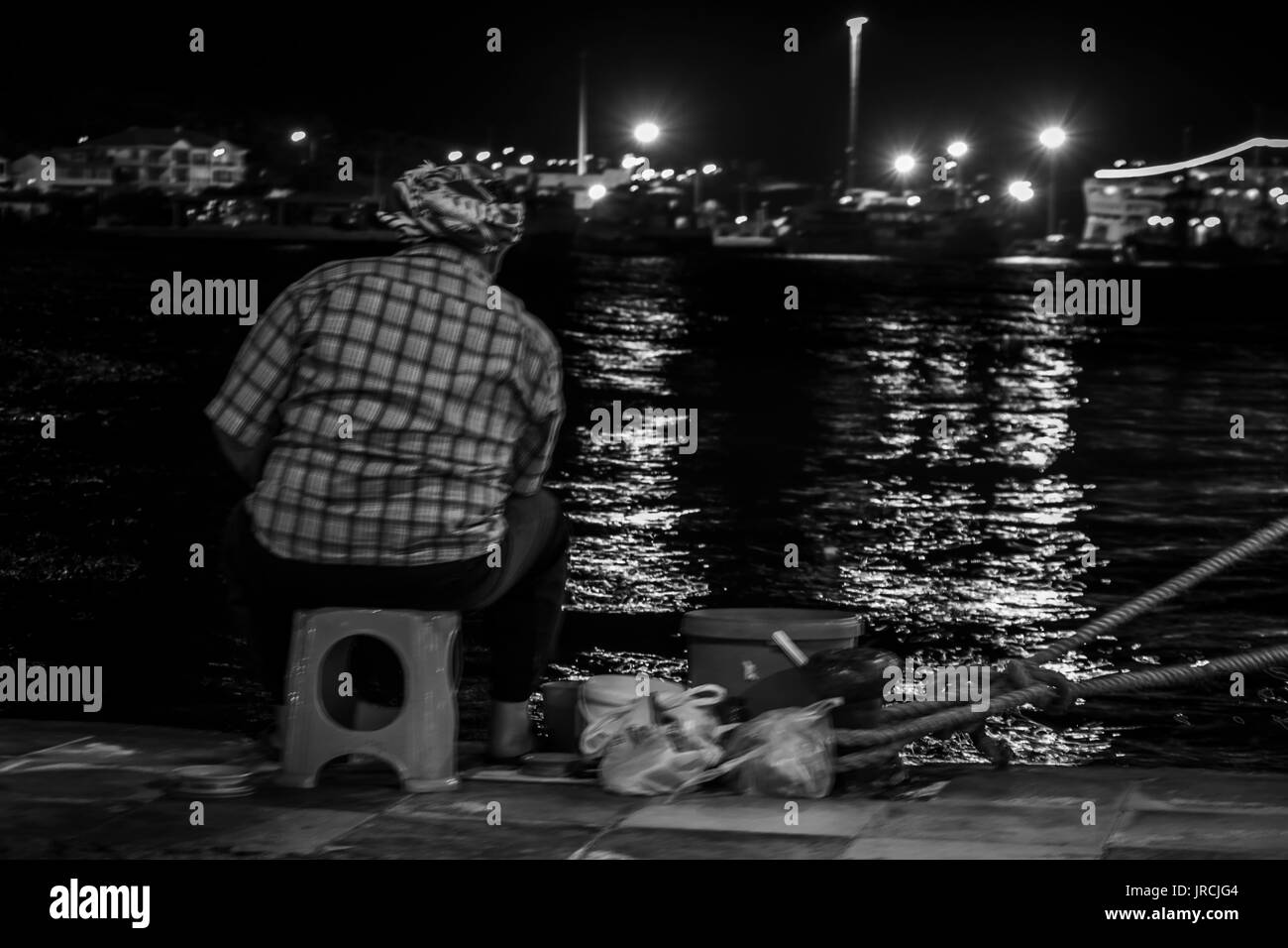 Fisherman in the night Stock Photo - Alamy