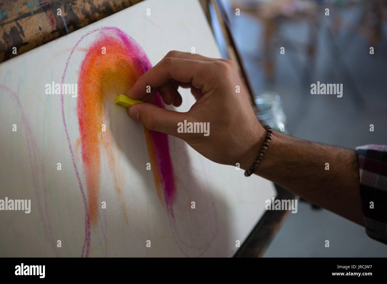 Cropped hand of artist painting on canvas in art class Stock Photo - Alamy
