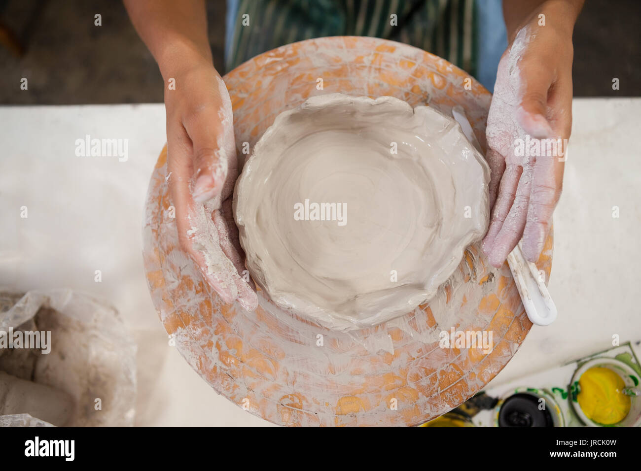 Mid section of potter molding clay in class Stock Photo - Alamy