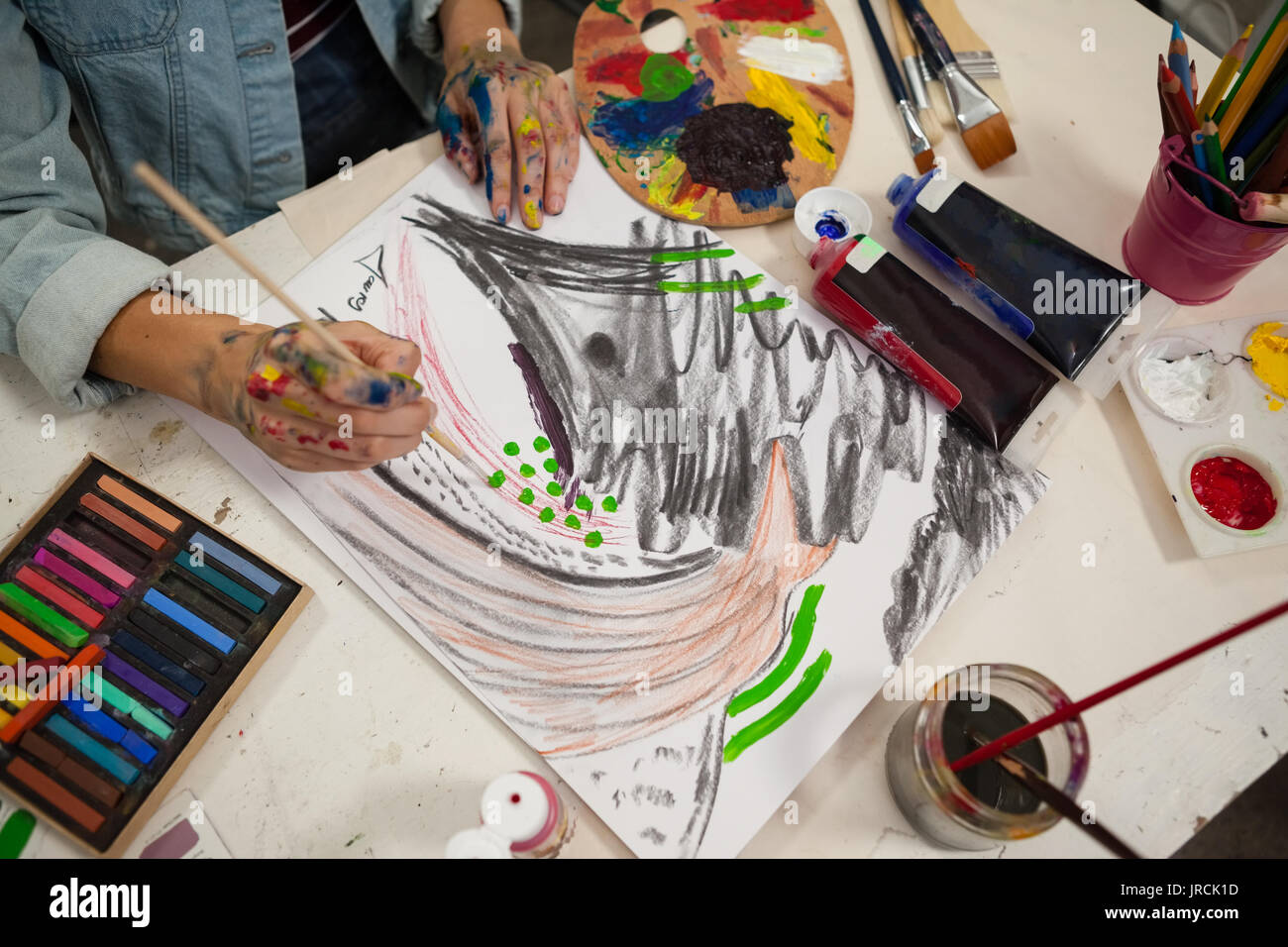 Mid-section of woman drawing on paper in drawing class Stock Photo - Alamy