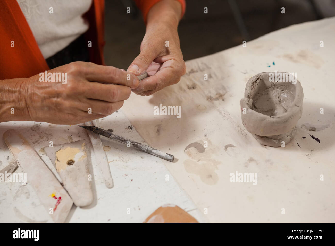 Mid section of woman molding clay in drawing class Stock Photo - Alamy