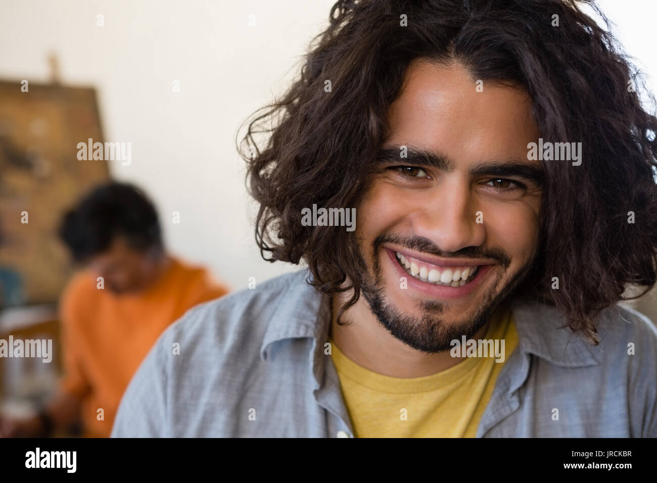 Close up portrait of smiling male artist in art class Stock Photo - Alamy