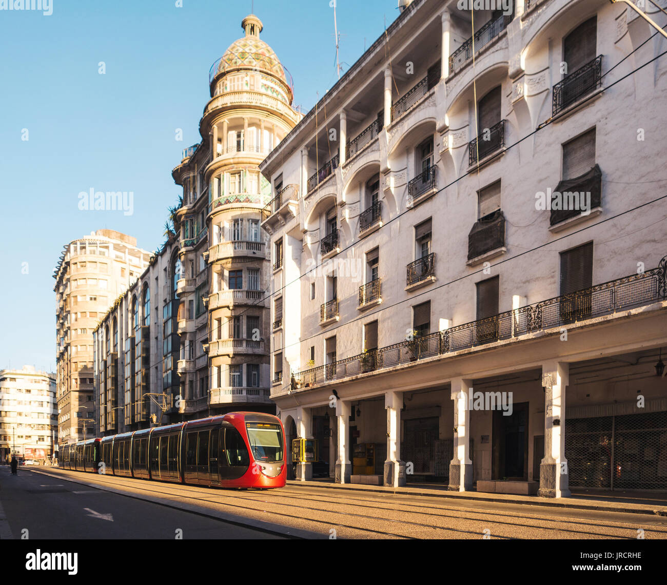 a tram passing on the railways between old buildings in Casablanca ...