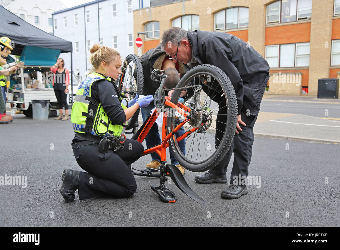 A bicycle registration event in Cambridge, UK. A female police officer ...