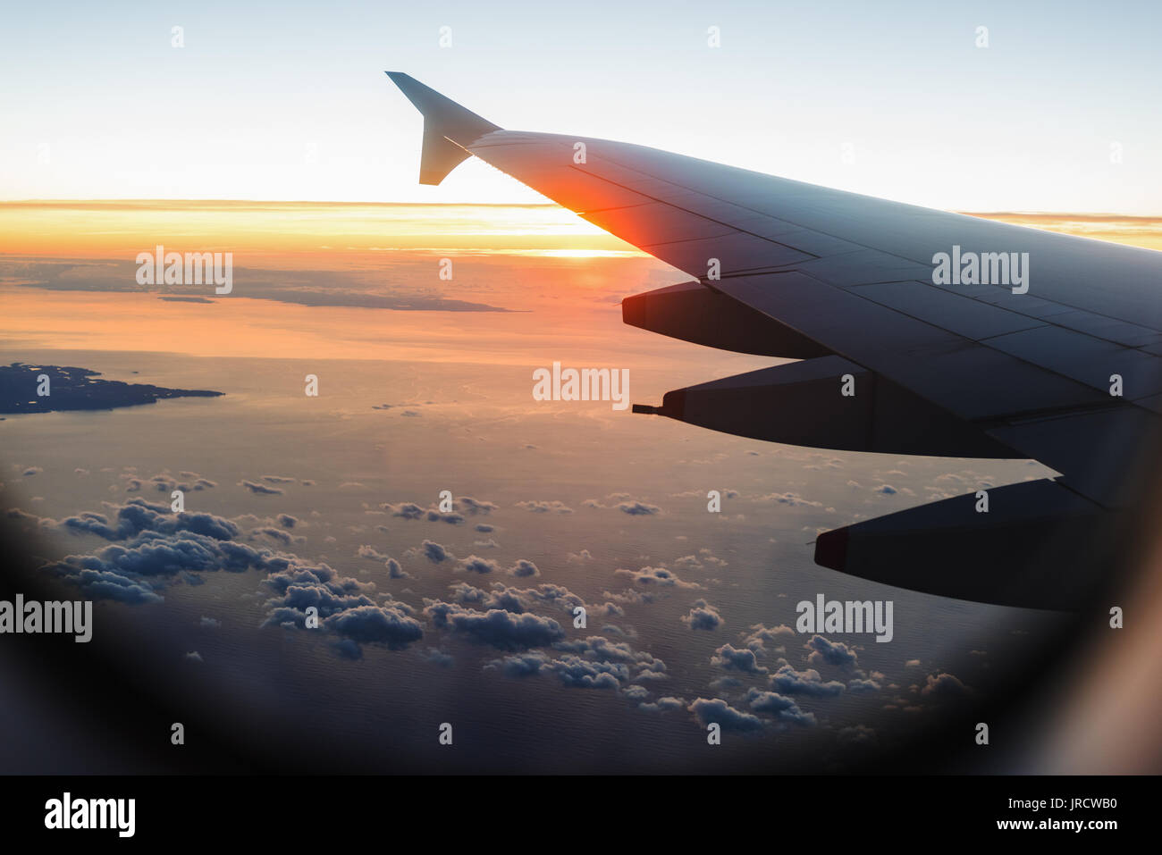 airplane wing in an orange sky Stock Photo - Alamy