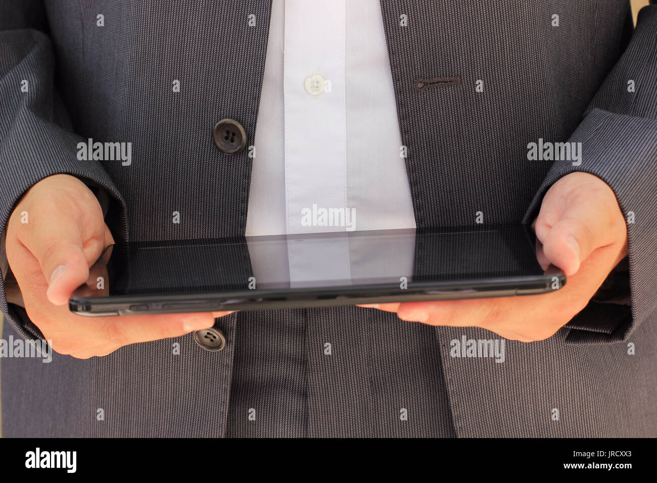 Scroll online businessman tablet hi-res stock photography and images ...