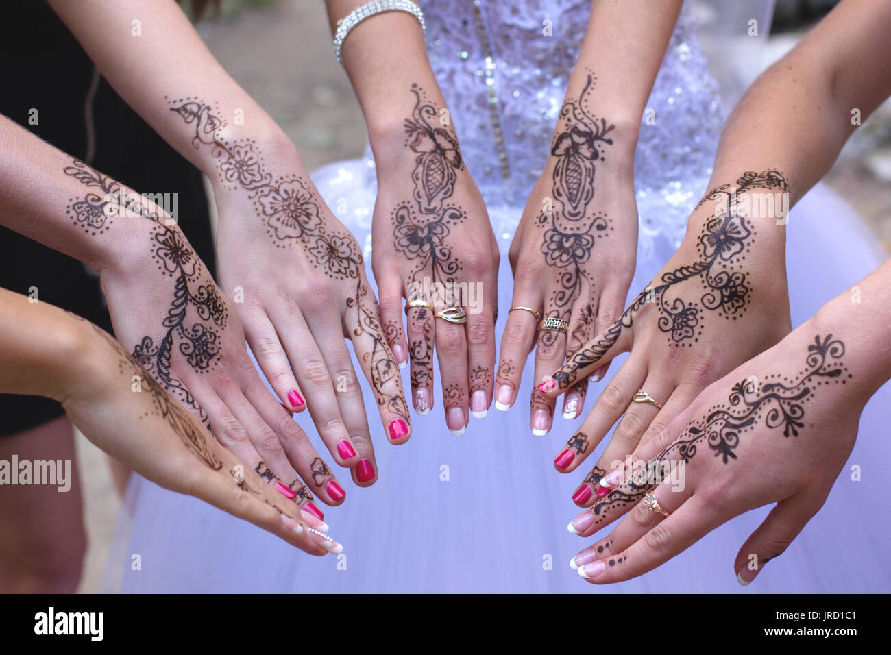 Henna paintings on women hands Stock Photo - Alamy