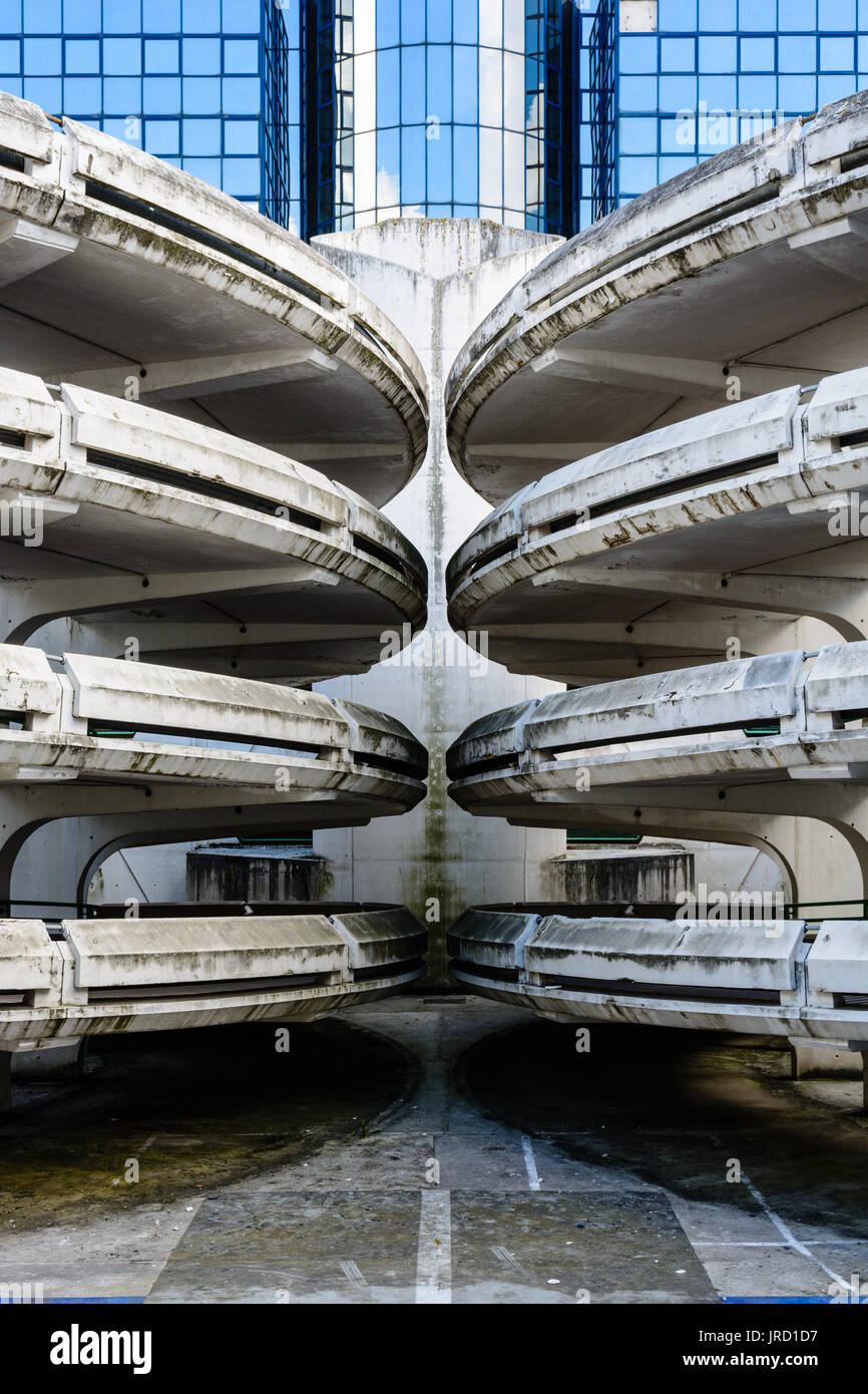 Spiral access ramps of an old decrepit concrete parking lot with a ...